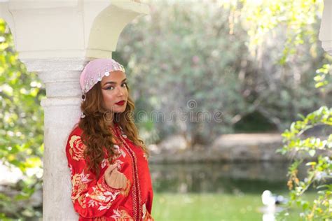 A Beautiful Moroccan Woman Wears A Traditional Moroccan Dress In Red