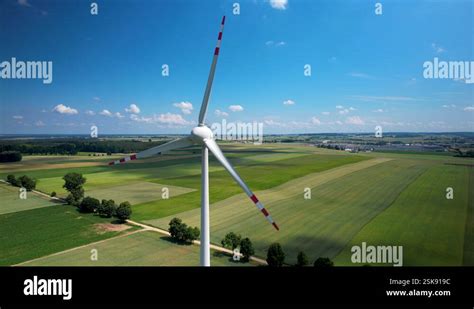 Drone Pulls Back From Red White Windmill Turbine Spinning Above Stock Video Footage Alamy