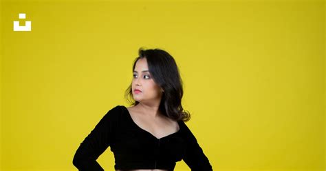 노란색 배경 앞에서 사진을 찍기 위해 포즈를 취하는 여자 사진 Unsplash의 무료 반바지 이미지