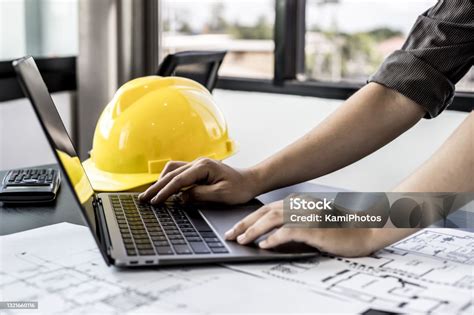 Engineers Are Typing On A Laptop Keyboard To Review The Design Of The