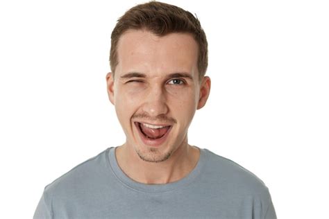 Premium Photo Man Winking Looking At The Camera On White Background