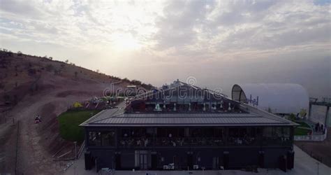 A Drone Takes Pictures Of A Mountain Cable Car Station Against The Backdrop Of A Sunset Sky