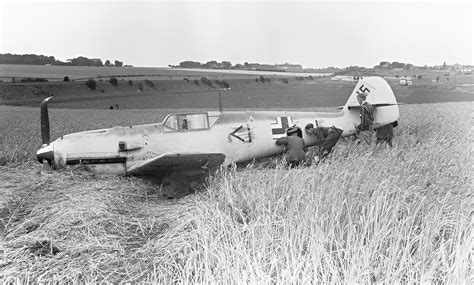 Airmen And Civilians Examine A Shot Down Messerschmitt Bf 109e 4 In A