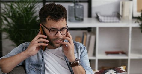 소파에 앉아 전화 통화를 하는 청년 전화를 사용하는 행복한 남자 사진 Unsplash의 실내 이미지