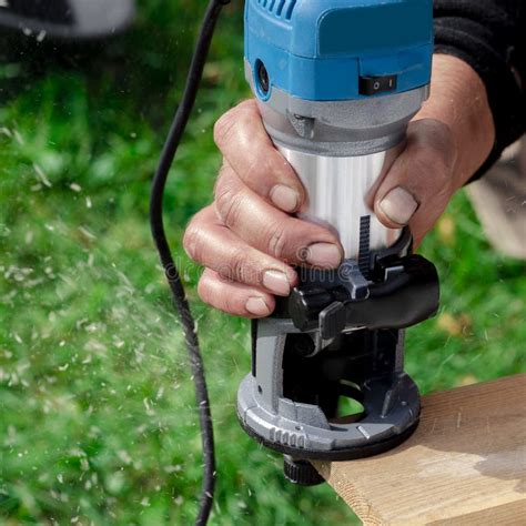 Closeup Of Carpenter With Hand Wood Router Machine At Work Closeup Of Routing A Bevel Into