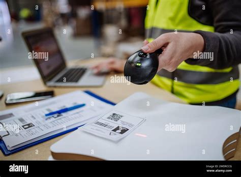 Female Warehouse Worker Holding Scanner Scanning The Barcodes On Products In Warehouse