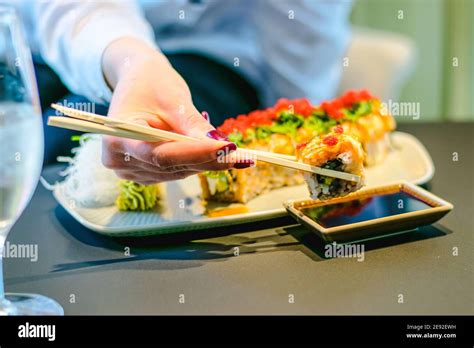 Woman Eating Sushi At A Restaurant Stock Photo Alamy