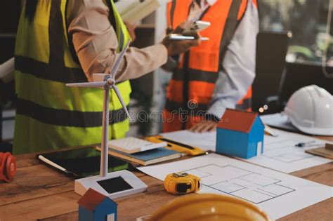 Engineers Are Helping To Design Work On Blueprints And Collaborate On Structural Analyzing Of