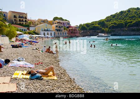 Tourists Sunbathing Topless On The Pebble Beach Of Sveti Stefan Summer Resort Montenegro Stock