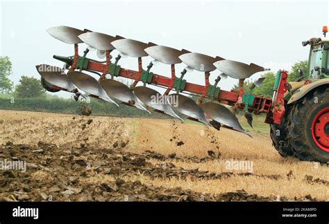 Tractor And Plough Attached Various Shots Of Tractor Ploughing A Field Farm Worker Tilling The