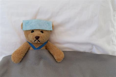 Premium Photo Teddy Bear Lying Sick In Bed Teddy Bear With