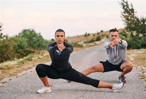 Romantic Couple Stretching Together After An Intense Morning Run Stock