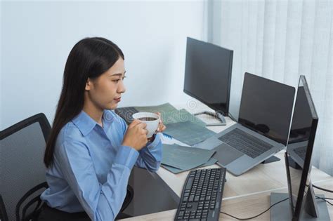 Asian Woman Was Drinking Coffee In The Early Morning While Contemplating The Program And Code On
