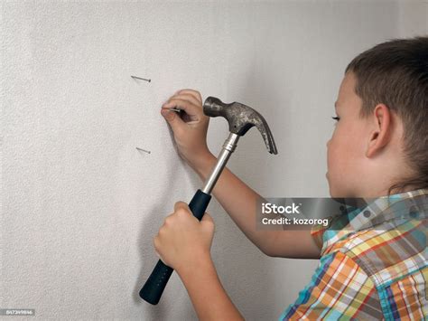 어린 소년 망치로 벽에 못을 망치는 재미 있는 아이 6 세 새 가족 홈 복구에 도움이 됩니다 아기 손톱과 망치 6 7 살에 대한 스톡 사진 및 기타 이미지 Istock