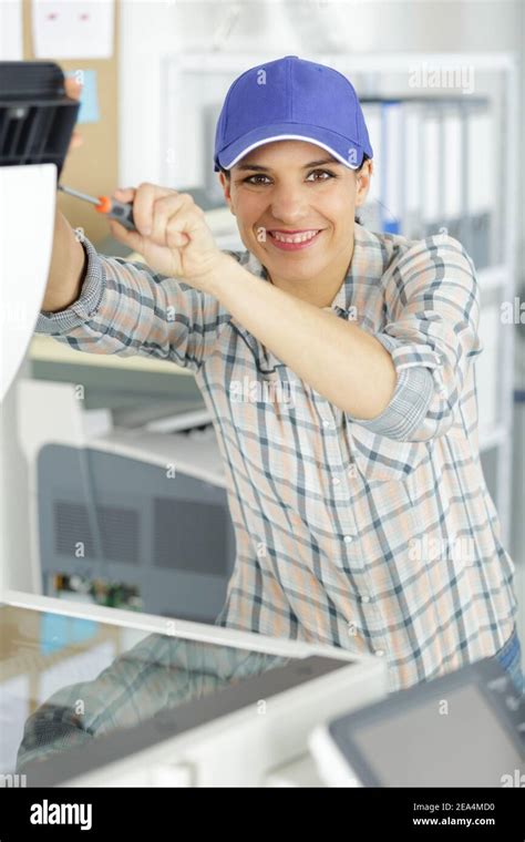 Female Technician Screwing A Printer Stock Photo Alamy