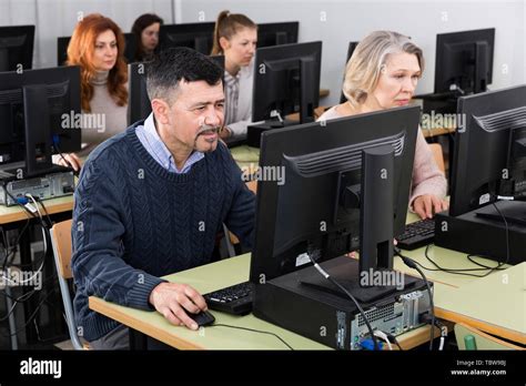 Portrait Of Focused Mature Man During Computer Classes At University Of