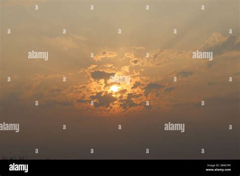 Sun Rays Are Shining Through The Clouds At Sunrise Or Sunset An