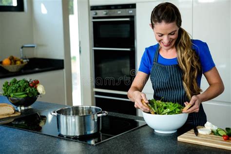 Smiling Woman Tossing A Salad For Dinner Stock Photo Image Of Fruit Holding
