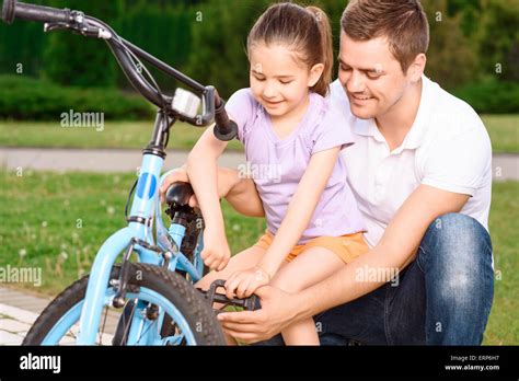 Father Teaching Babe To Ride A Bike Stock Photo Alamy