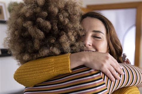 Carefree And Joyful Female Couple Hugging Each Other At Home Head Shot