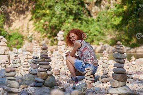 Woman Stacking Pebbles On A River Bed Stock Image Image Of Concept Group 293383347