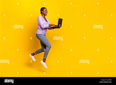 Full Length Profile Photo Of Energetic Person Run Jump Use Wireless Netbook Isolated On Yellow