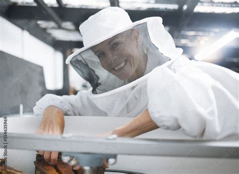 Woman Beekeeper Suit And Honey Production Manufacturing And Process In Workshop Factory Or