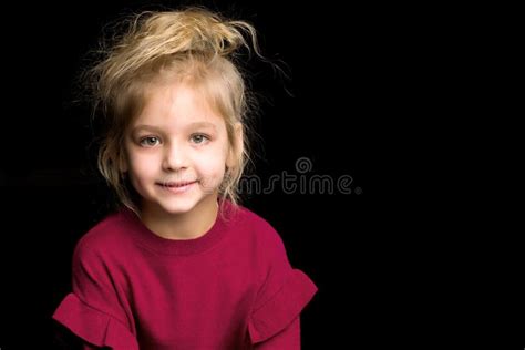 Close Up View Of Cute Smiling Blonde Girl Posing On Black Background