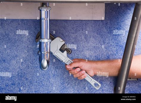 Man Repairing Pipe With Wrench Close Up Stock Photo Alamy