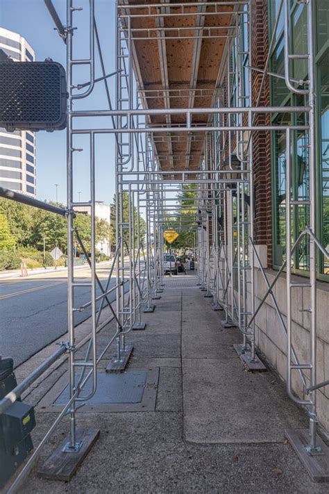 Pedestrian Path Under Scaffolding On The Side Of The Road Along A Building Under Repair