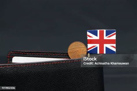 어두운 배경의 검은 색 지갑에 한 페니 영국 소수점 동전 돈과 미니 유니온 잭 플래그 스틱 강철에 대한 스톡 사진 및 기타 이미지 Istock