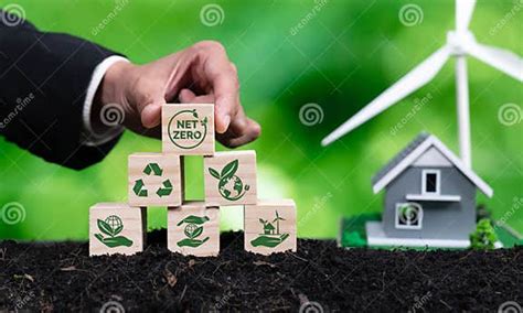 Businessman Putting Net Zero Symbol Cube On Stack Top For Green Corporate Alter Stock Image