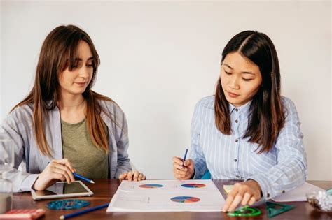 Free Photo Girls Researching Charts On Table