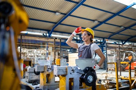 Premium Photo Female Factory Worker Operating Industrial Machine In Production Line