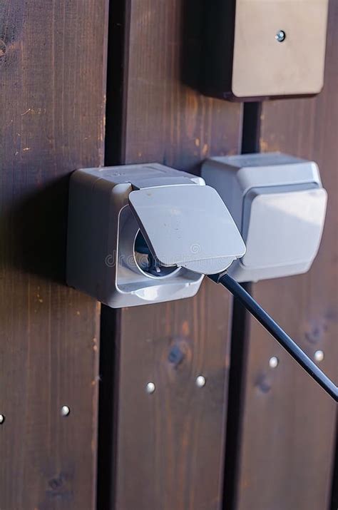 Outdoor Electrical Sockets On Wood Wall Plugged In Connection Power Supply Stock Image