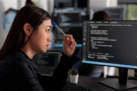 Premium Photo Pensive Asian It Programmer Thinking At Html Script