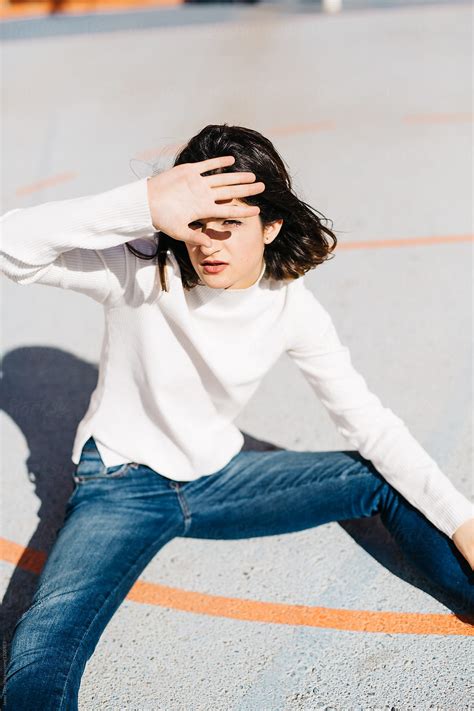 Woman Covering Face From Sunlight By Stocksy Contributor Javier Díez