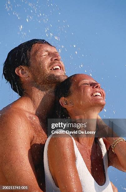 Caucasian Couple Taking Shower Together Outdoors Photos And Premium