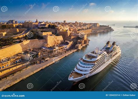 Valletta Malta Cruise Ship Sailing Into Grand Harbor At Sunrise With