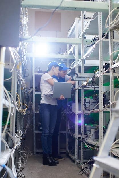 Premium Photo Man And Woman On The Farm For The Extraction Of Crypto Currencies Bitcoin Mining