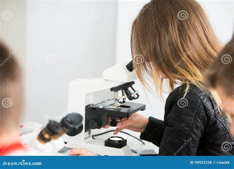 Girl At The Lab Looking Through Microscope Stock Photography CartoonDealer Com 94922258