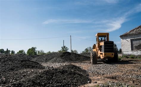 Premium Photo Yellow Loader Moving With Uploaded Bucket With Stone