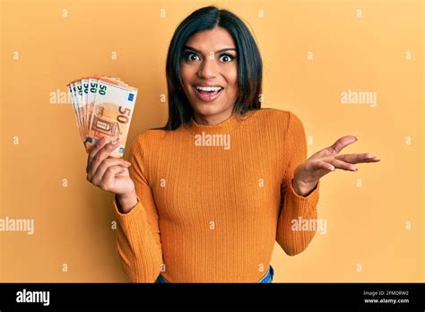 Young Latin Transsexual Transgender Woman Holding Bunch Of 50 Euro Banknotes Celebrating