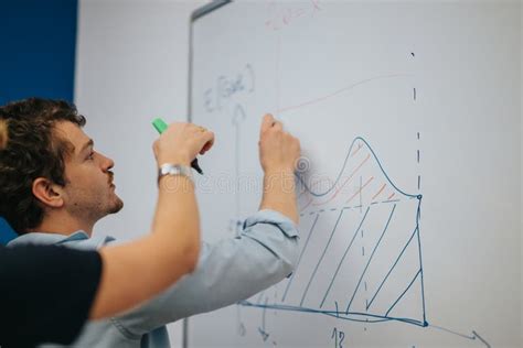 Student Explaining A Graph On A Whiteboard In Classroom Setting Stock