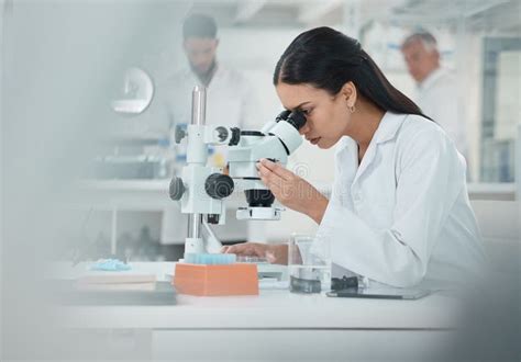 Science Is About Complex Analytical Processes A Young Scientist Using A Microscope In A Lab