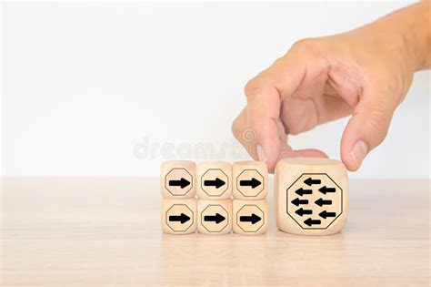Hand Chooses Arrow Icon Point To The Opposite Side On Cube Wooden Block