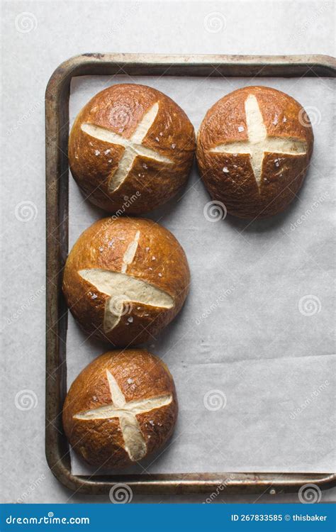 Pretzel Buns On A Parchment Lined Baking Sheet Stock Image Image Of