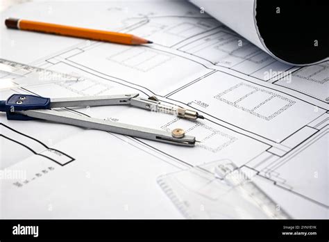 Architectural Project With Compass Pencil And Rolled Blueprints Lying On Construction Plans Of