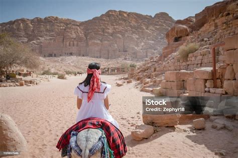 페트라 고 대 도시 요르단에 있는 당나귀를 타고 흰색 드레스에 아시아 여자 관광 유네스코 세계 문화 유산으로 지정 된 중동을 여행 하세요 요르단에 대한 스톡 사진 및 기타