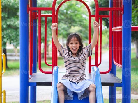 Cute Girl Playing In The Playground During Summer Vacation Happy Girl Having Fun On A Colorful